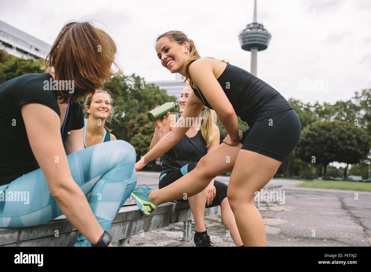 Four women relaxing after workout Stock Photo - Alamy