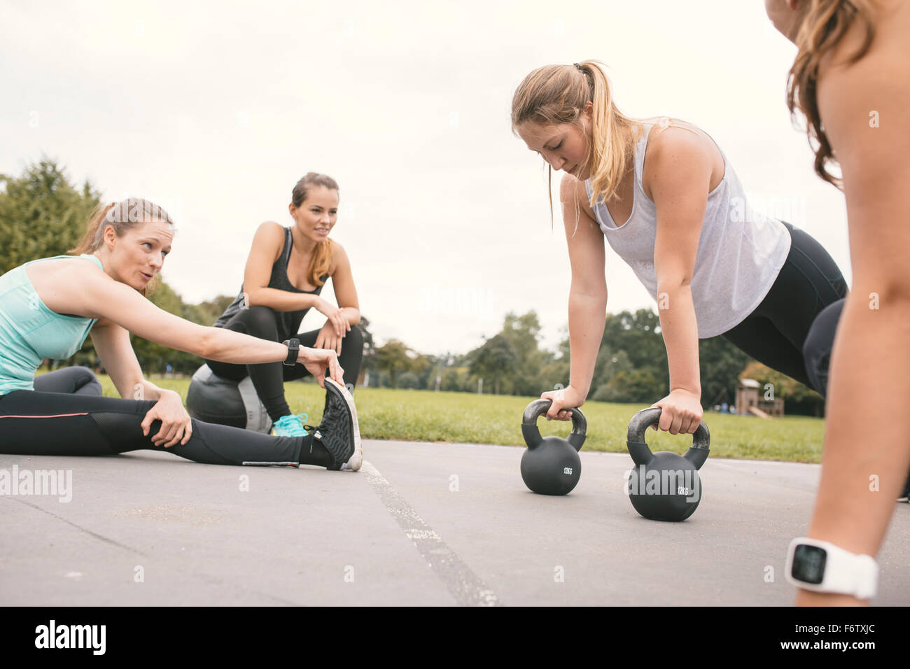 Four women having an outdoor boot camp workout Stock Photo - Alamy