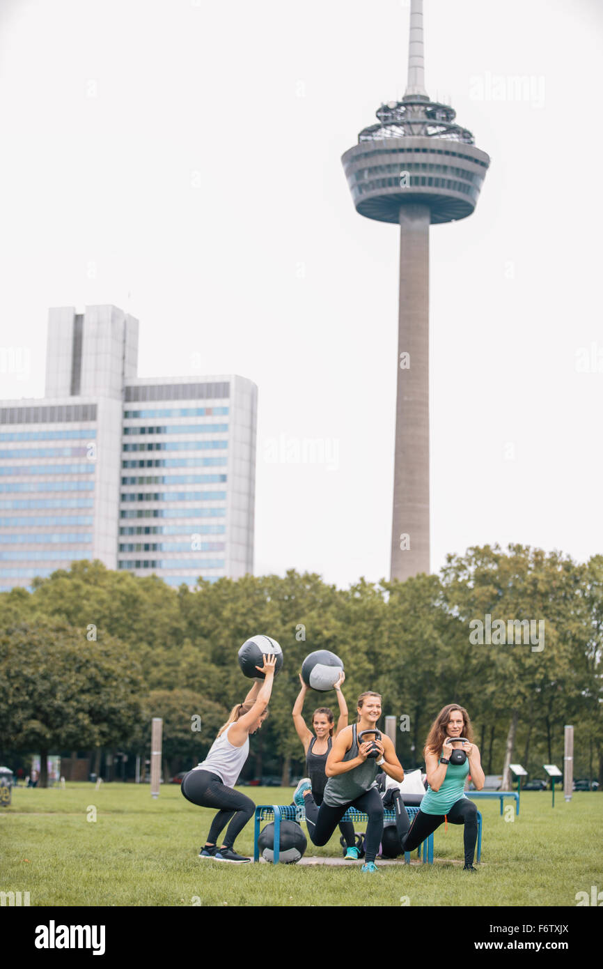 Four women having an outdoor boot camp workout Stock Photo - Alamy