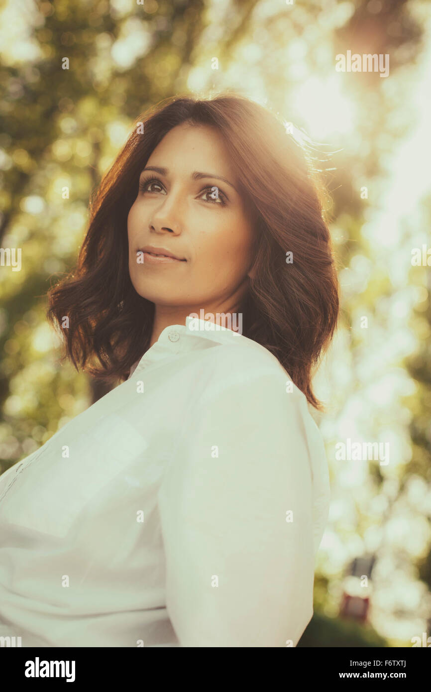 Portrait of romantic woman with brown hair standing at backlight Stock ...