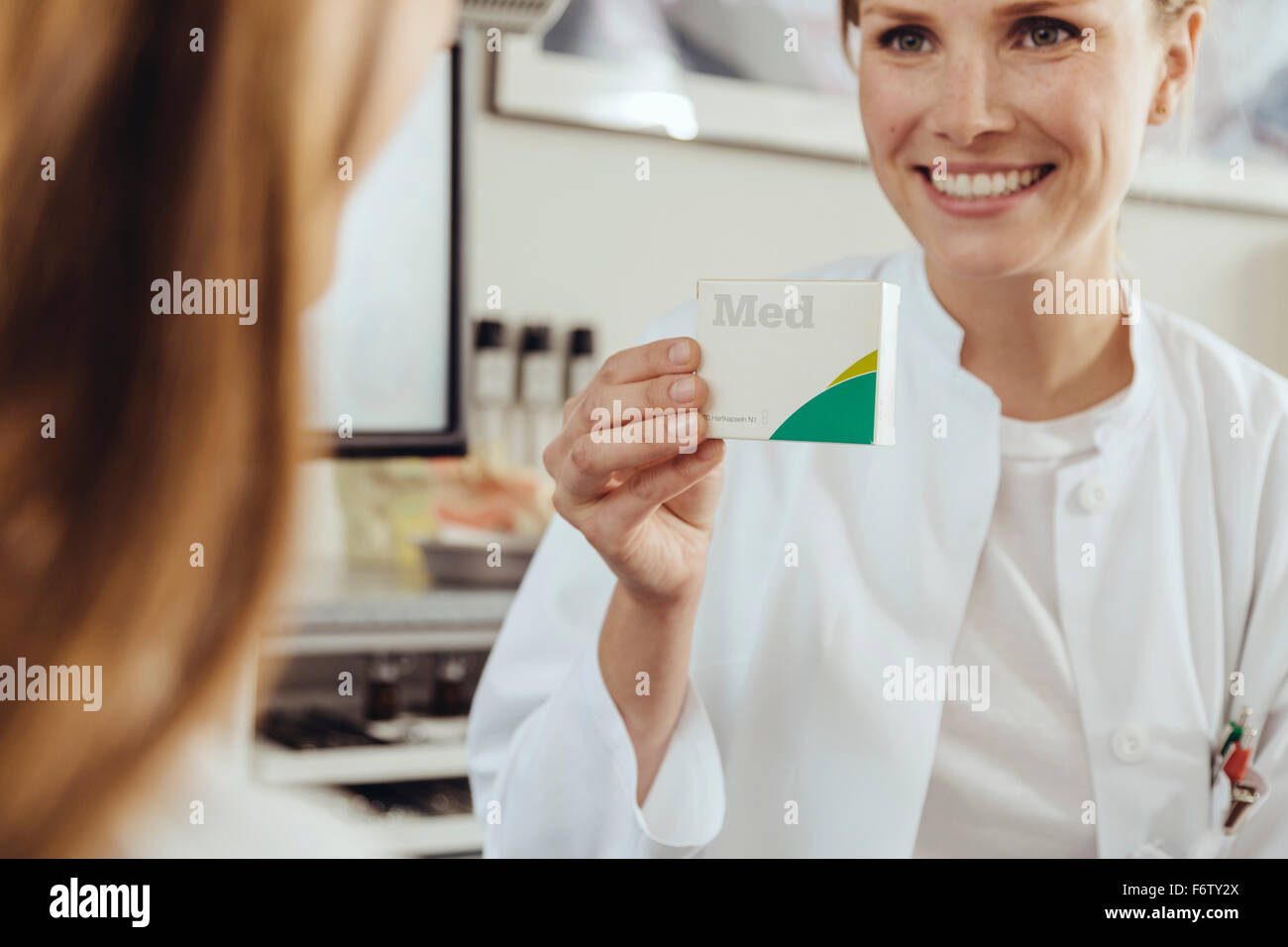 Doctor showing patient medication Stock Photo - Alamy