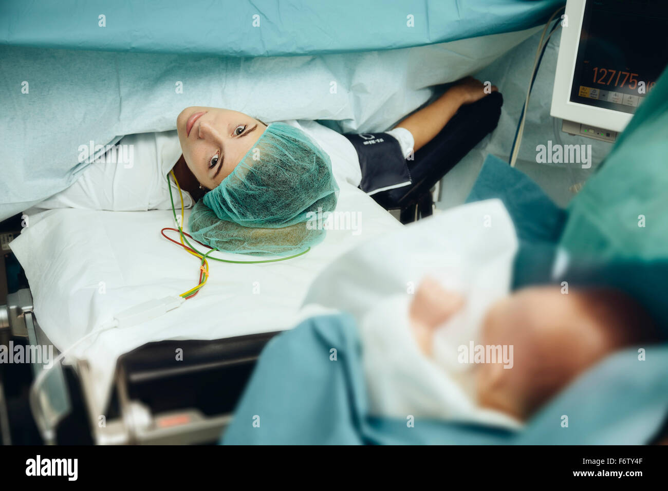 Operating room nurse bringing baby to mother after c-section Stock ...