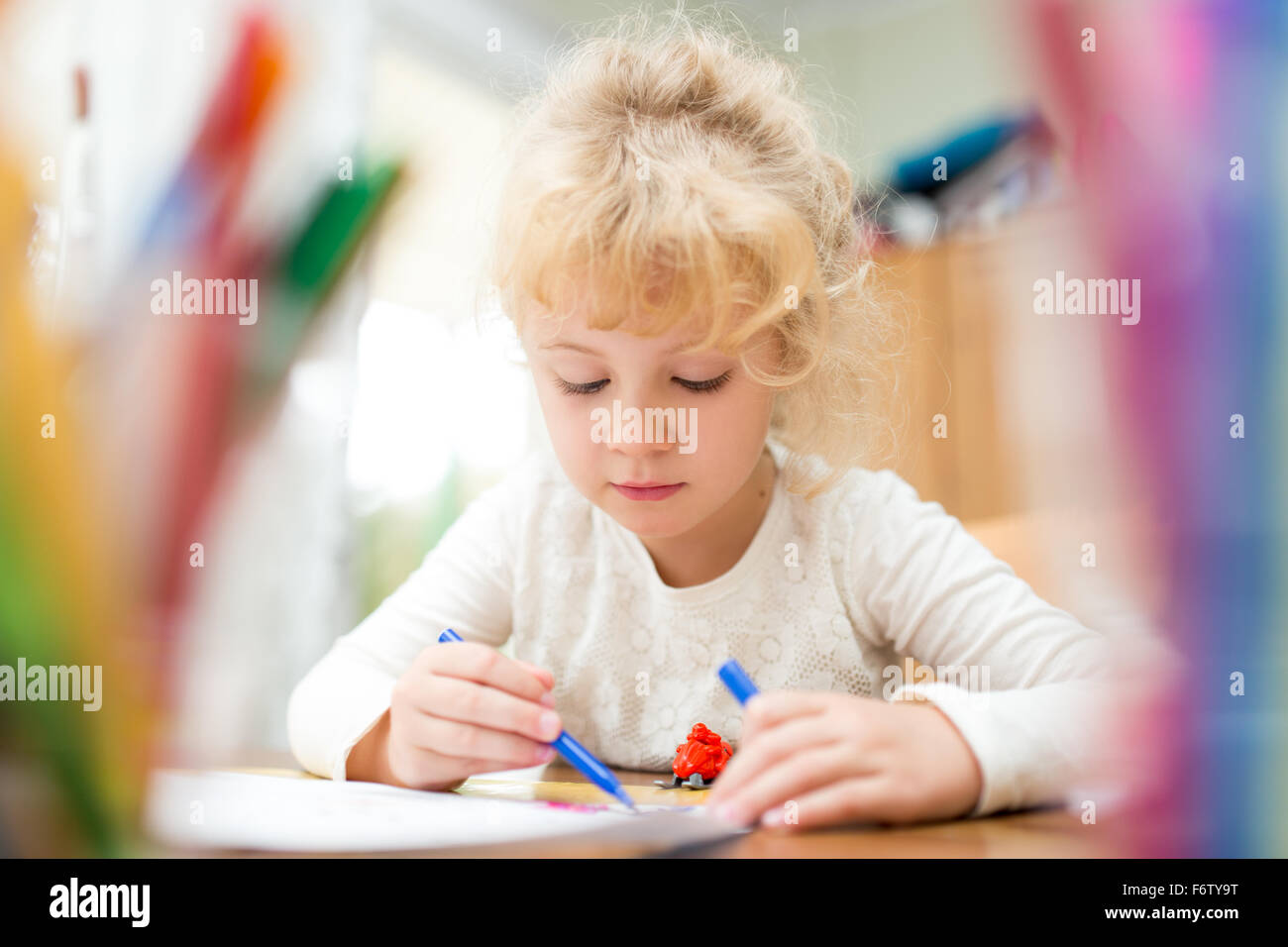 Portrait of child girl drawing at home Stock Photo - Alamy
