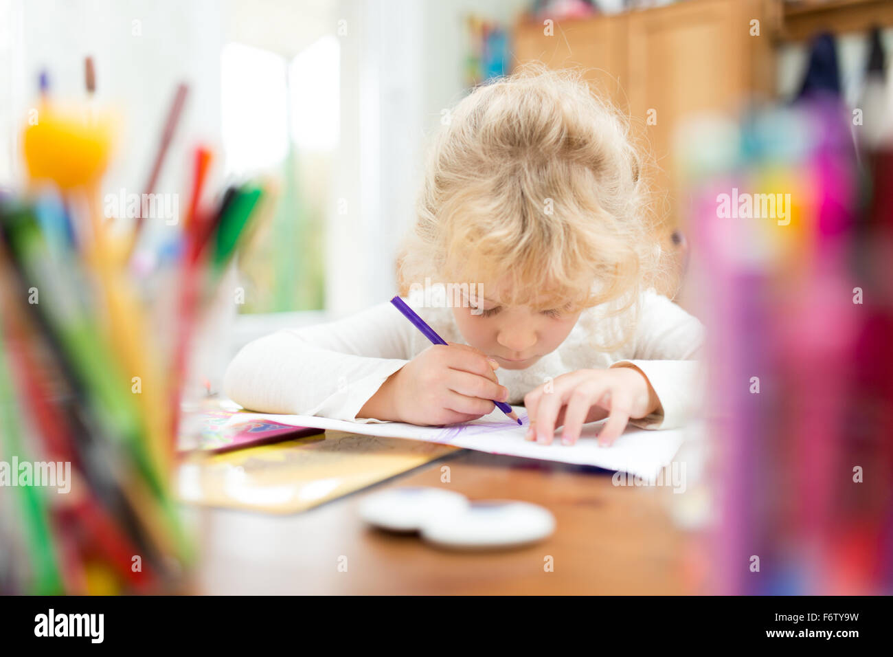 Portrait of child girl drawing at home Stock Photo - Alamy