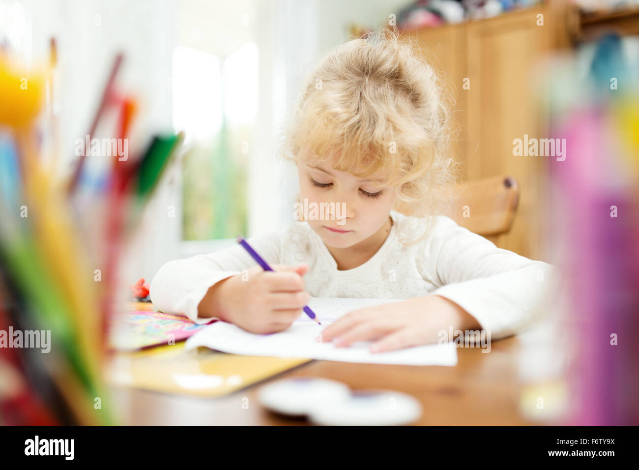 Portrait of child girl drawing at home Stock Photo - Alamy