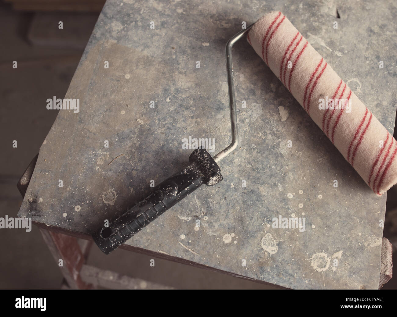 Paint roller with the old background Stock Photo - Alamy