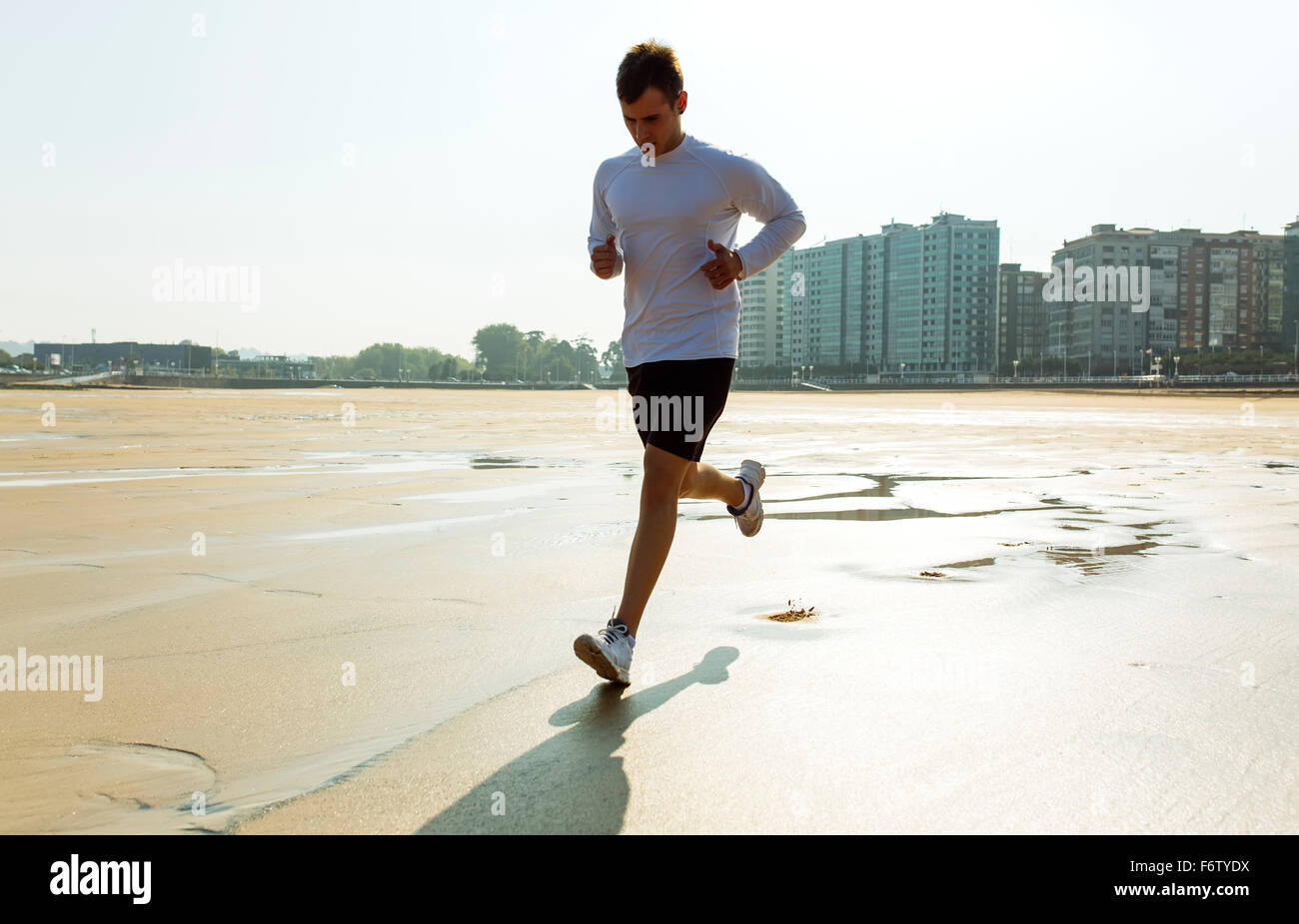 Spain, Asturias, Gijon, young man running on the beach Stock Photo - Alamy