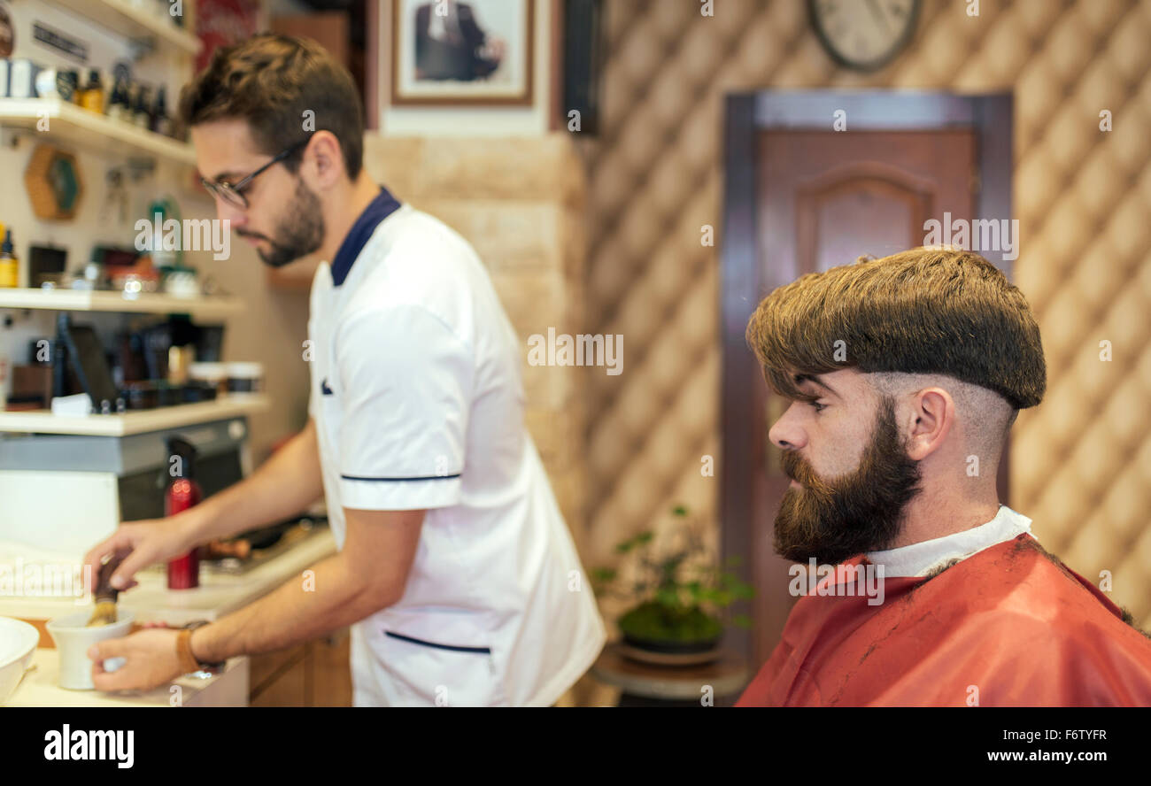 Barber and customer in a barber shop Stock Photo - Alamy