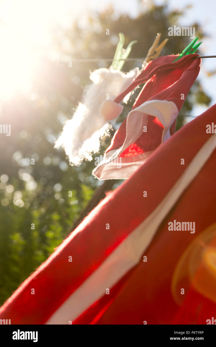 Santa costume handing on clothes line to dry Stock Photo - Alamy