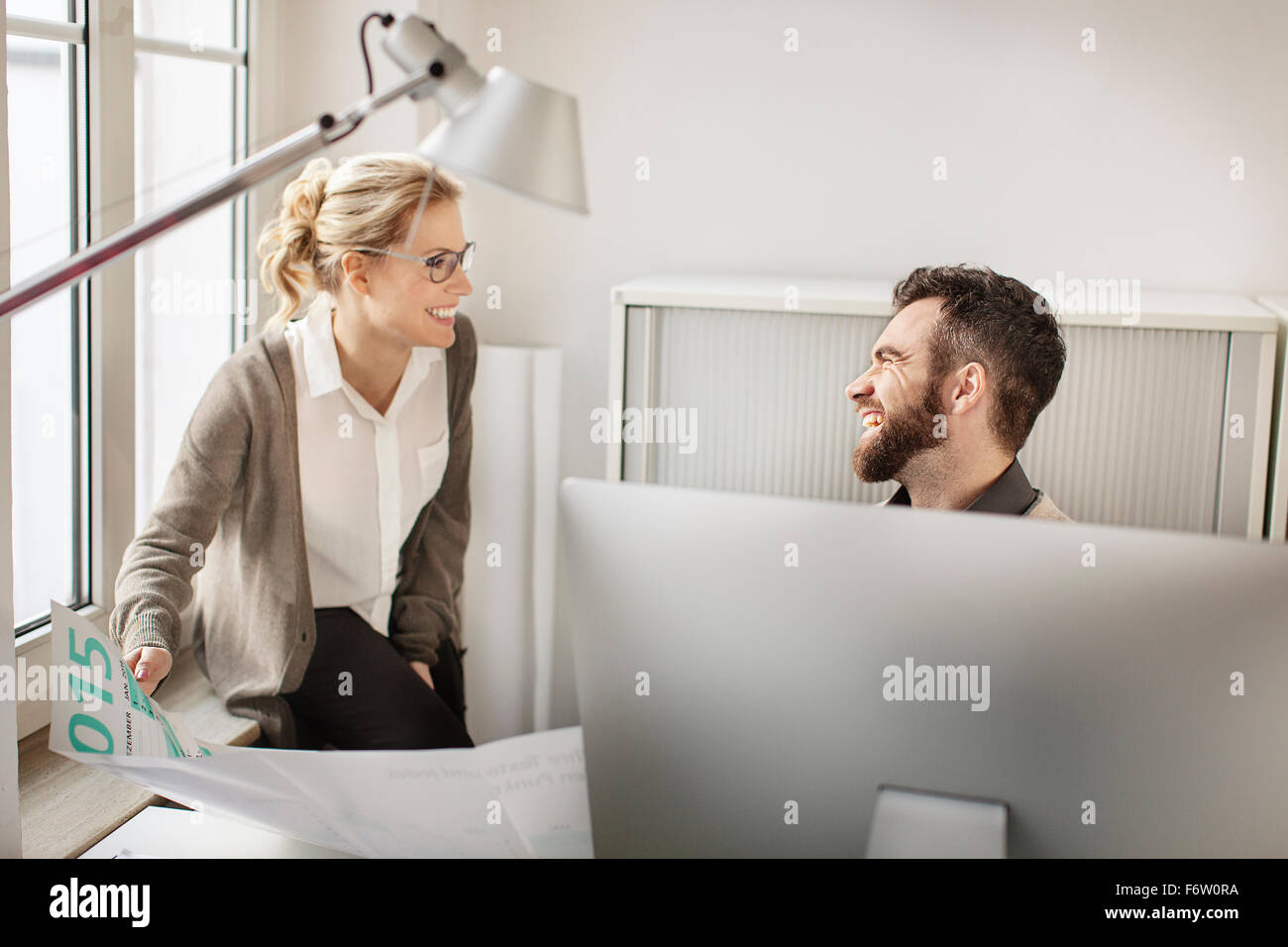 Two happy colleagues in office with calendar Stock Photo - Alamy