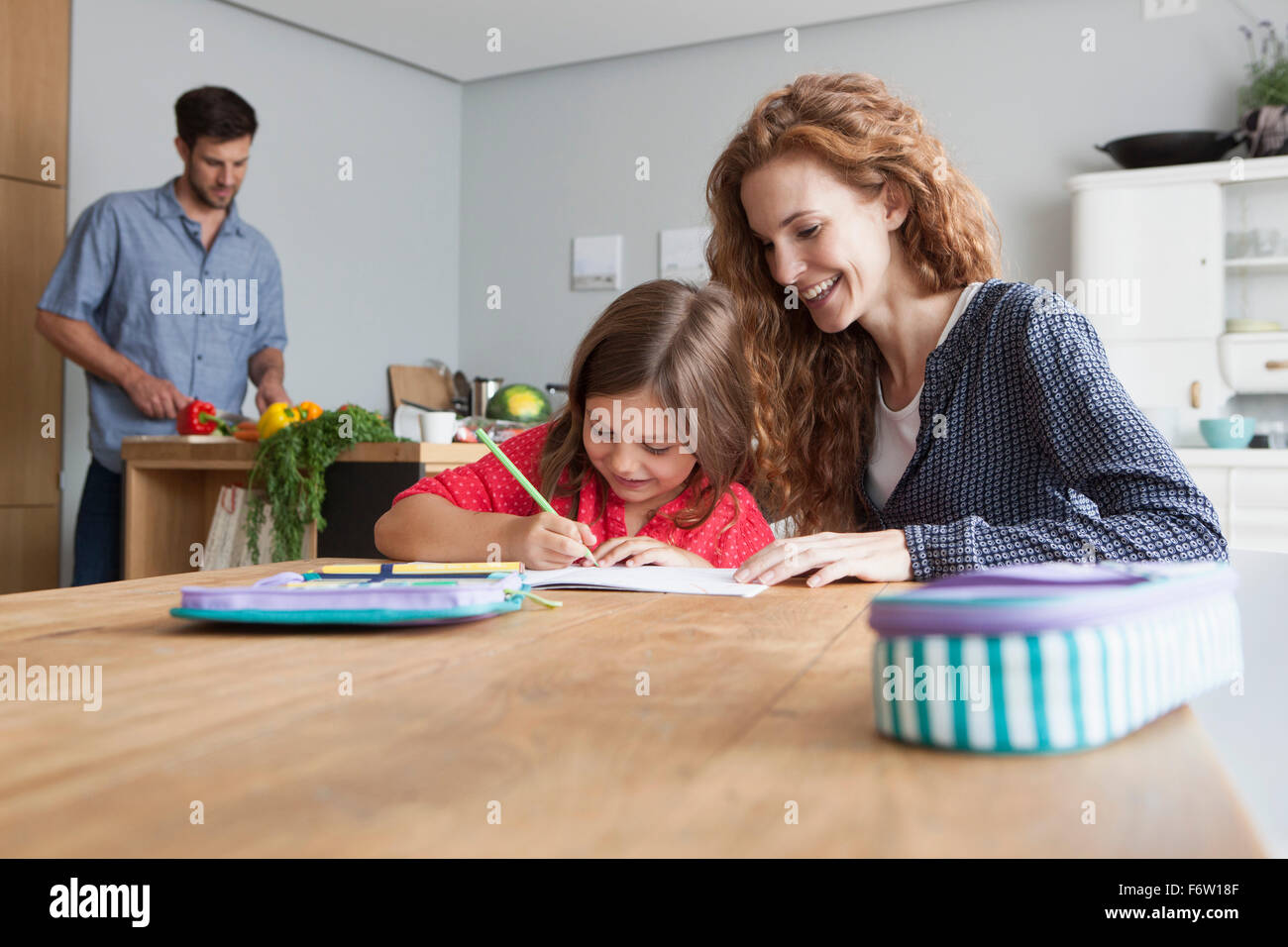 Little girl doing homework at the kitchen table Stock Photo - Alamy
