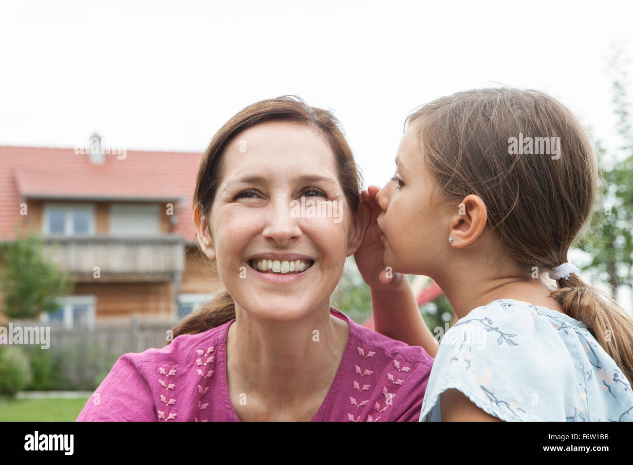 Whispering child adult hi-res stock photography and images - Alamy