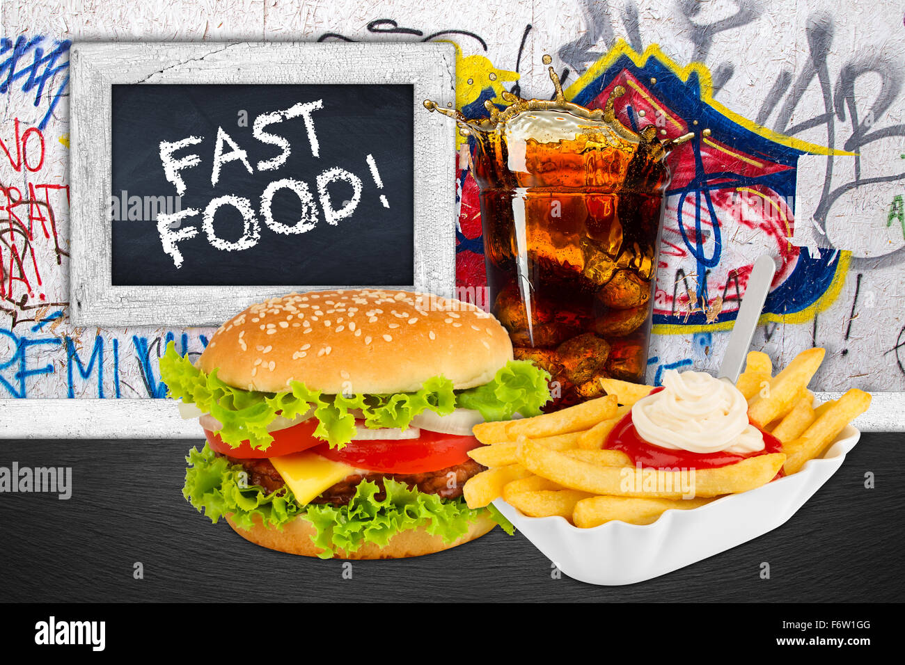Fast food meal in front of graffiti wall Stock Photo - Alamy