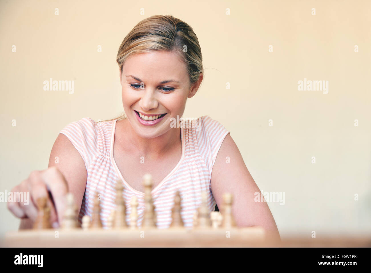 Portrait of woman playing chess Stock Photo - Alamy