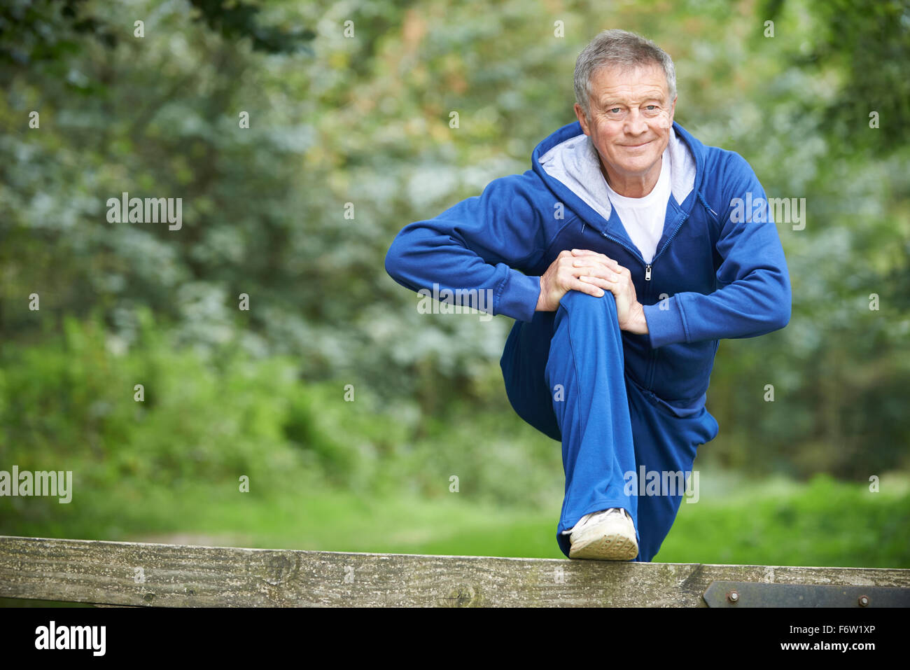 Senior Man Stretching On Countryside Run Stock Photo - Alamy