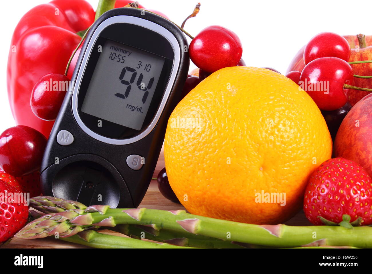 Glucose meter with fresh ripe fruits and vegetables, concept of ...