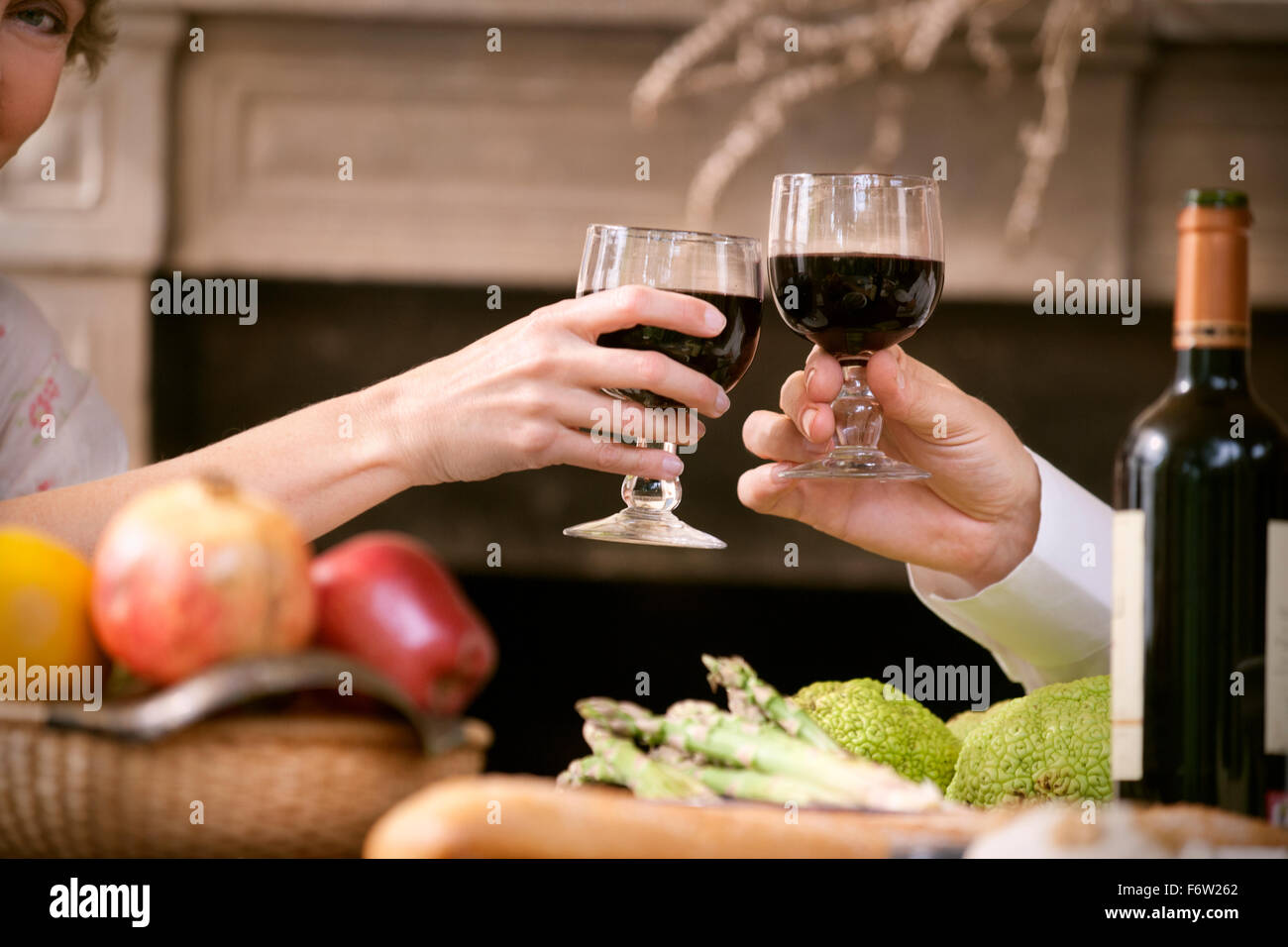 Hands of couple toasting with red wine Stock Photo - Alamy