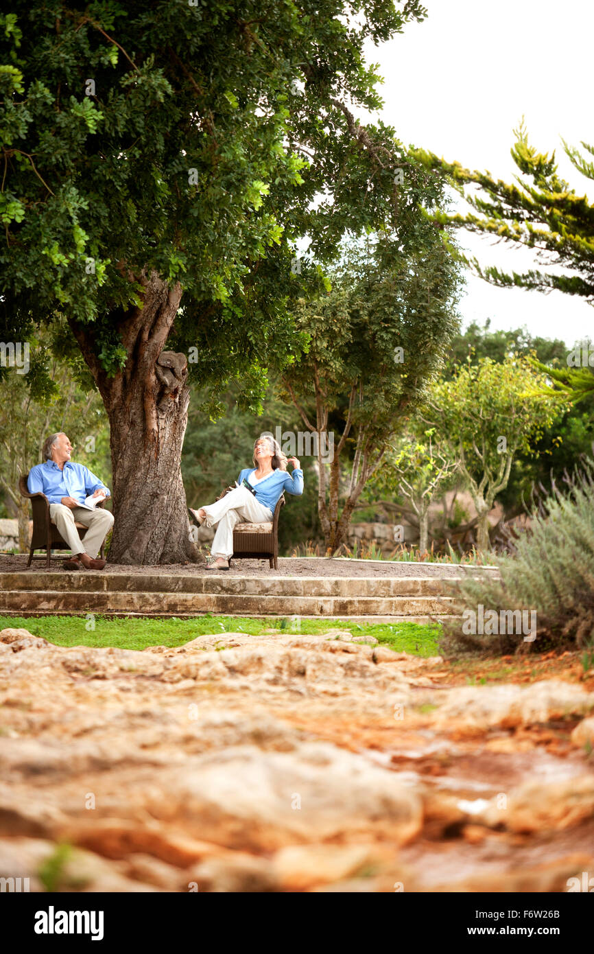 Woman under tree relaxing book hi-res stock photography and images - Alamy