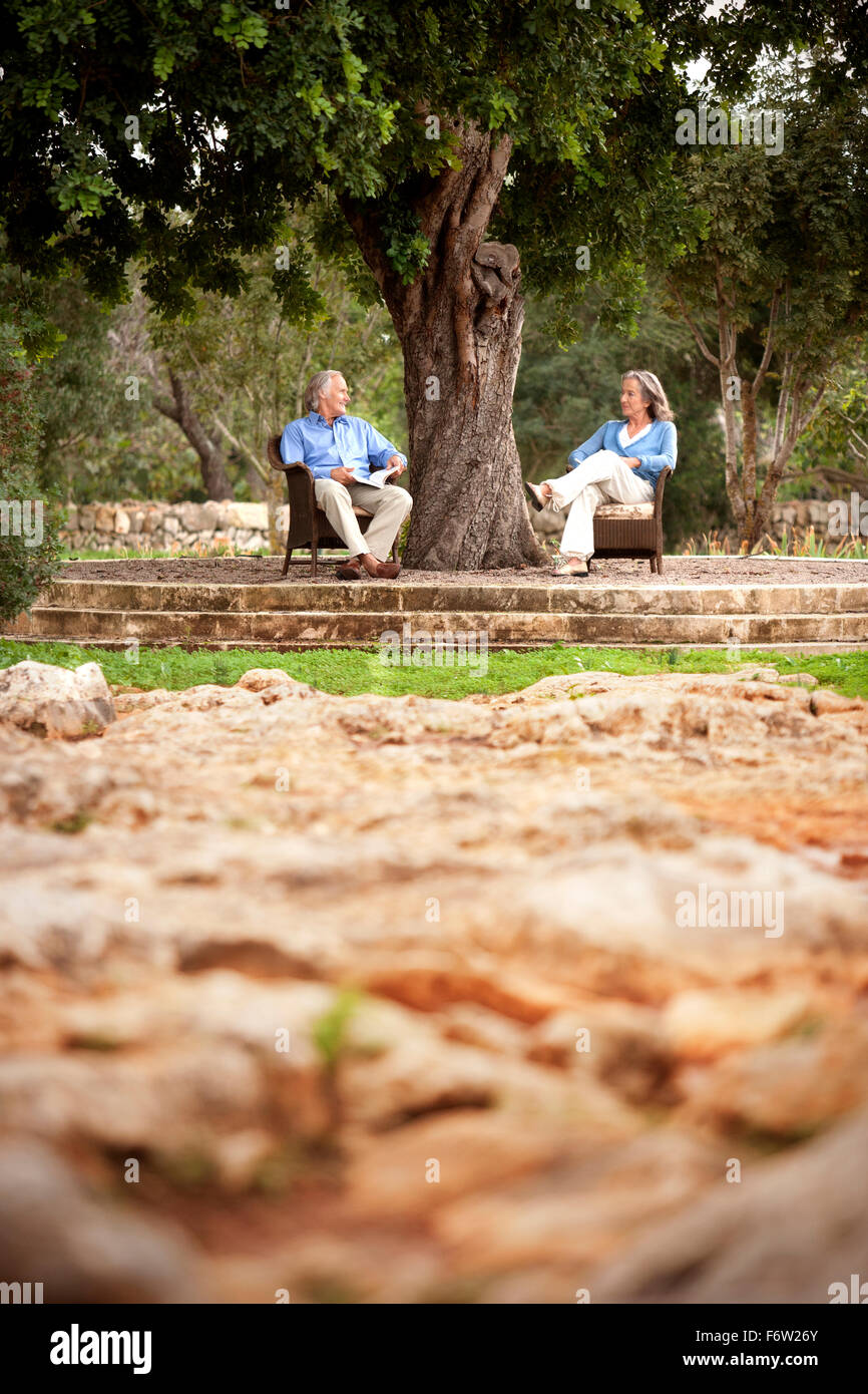 Two men sitting under tree hi-res stock photography and images - Alamy