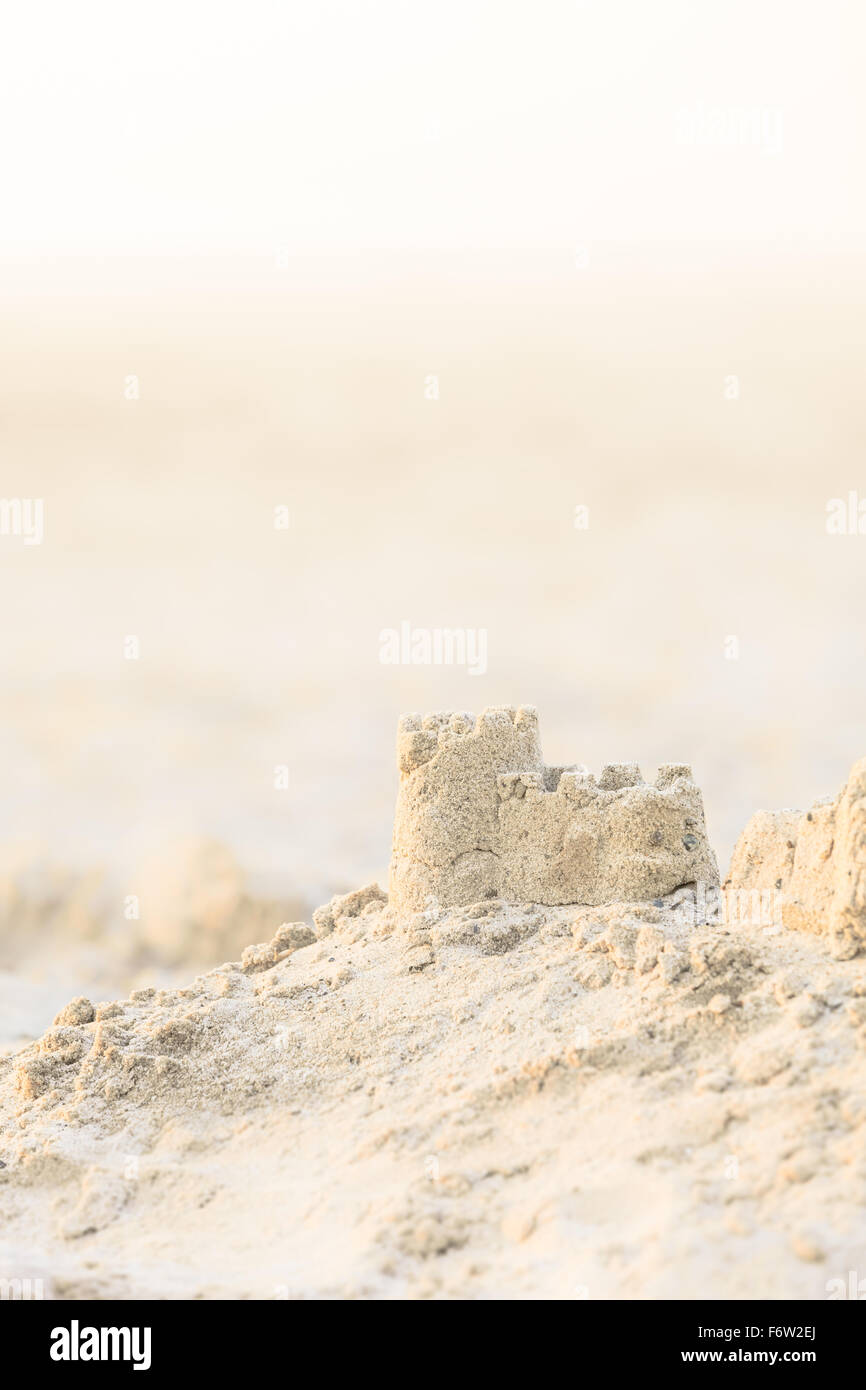 Small sand castle at the beach at the end of a bright day in front of ...