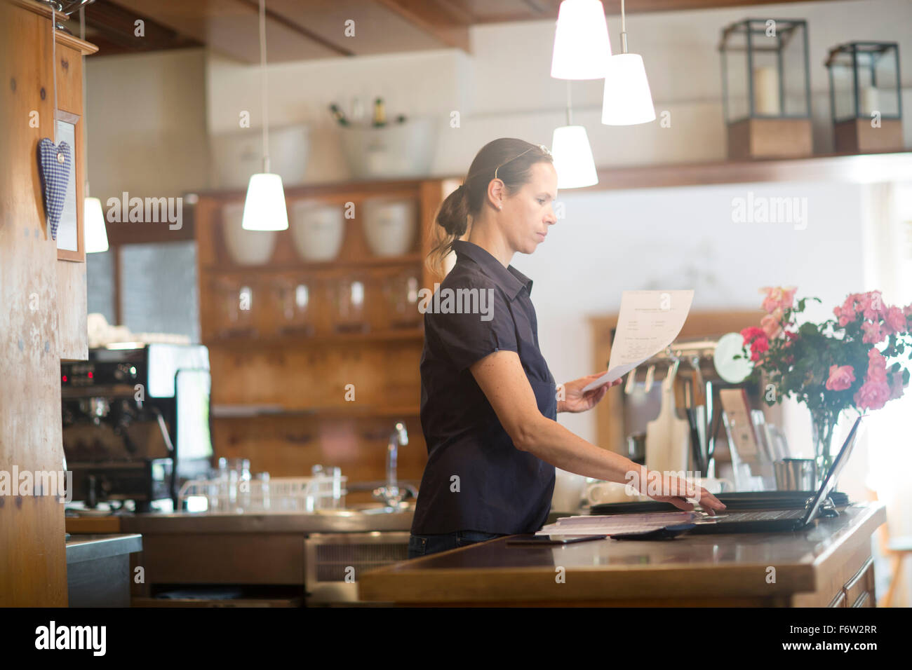 Waitress preparing bill at counter Stock Photo - Alamy