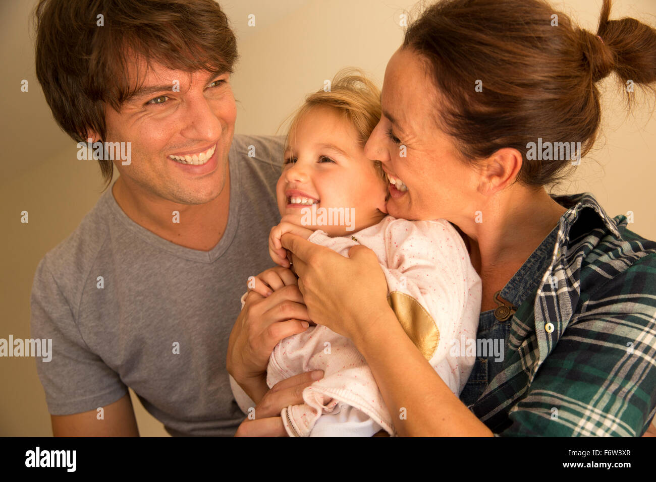 Happy family of three Stock Photo - Alamy