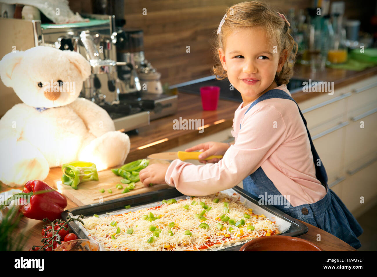 Girl in kitchen preparing pizza Stock Photo - Alamy