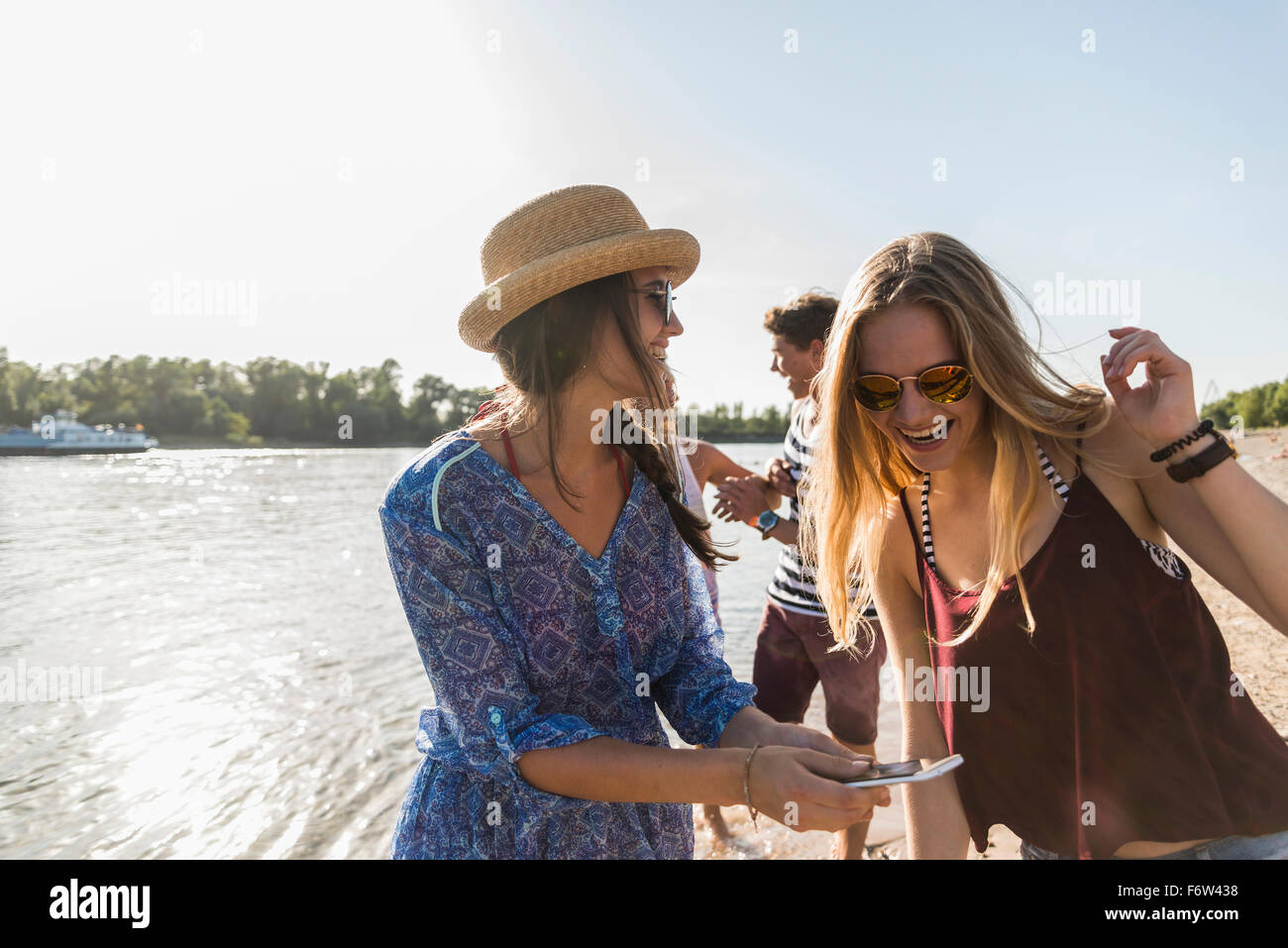 Happy friends at the river in summer Stock Photo - Alamy
