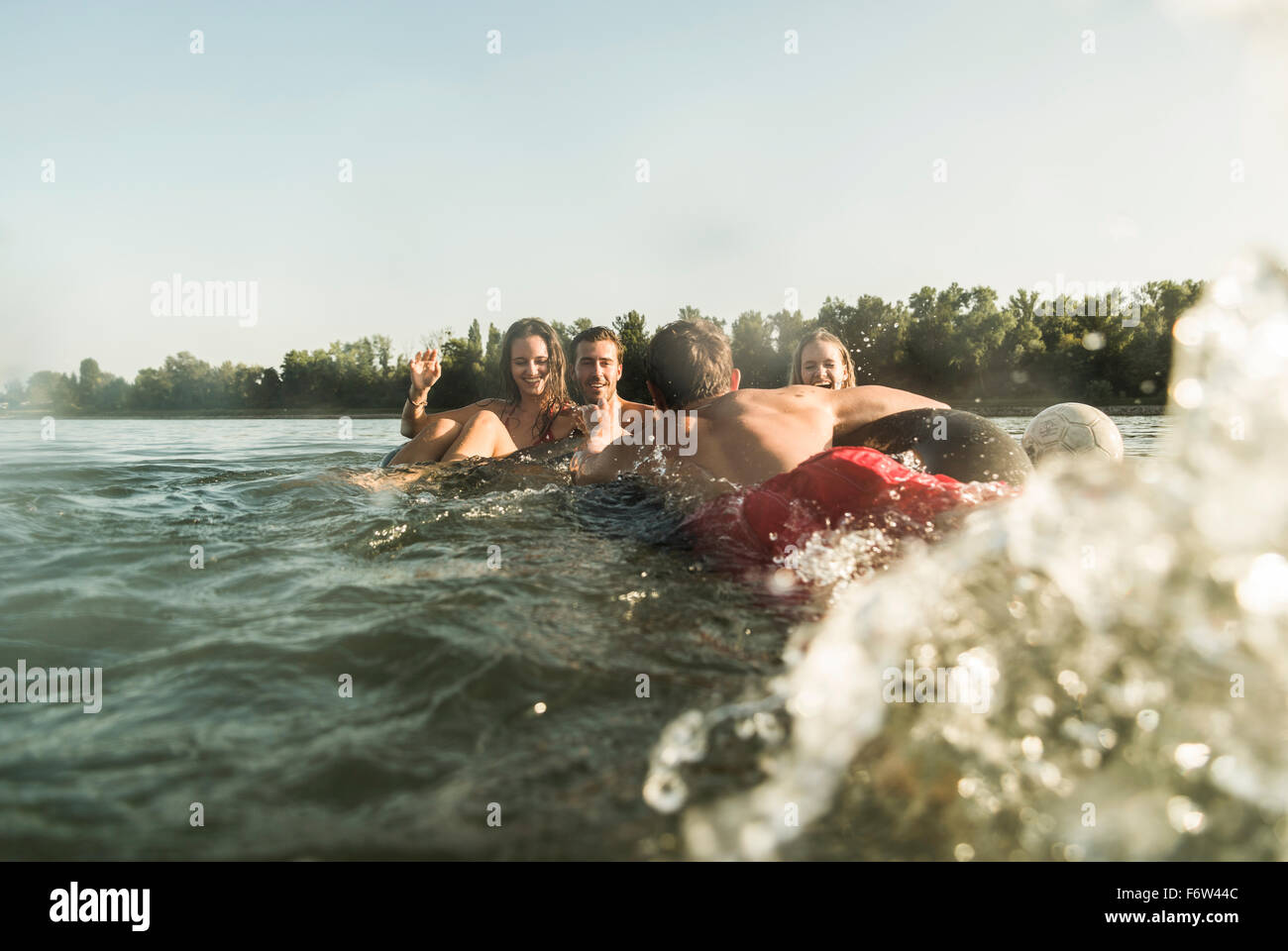 Happy friends in water Stock Photo - Alamy