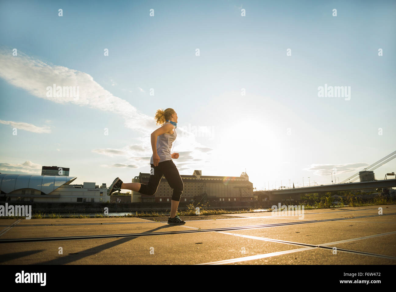 Teenage girl running by the riverside Stock Photo - Alamy
