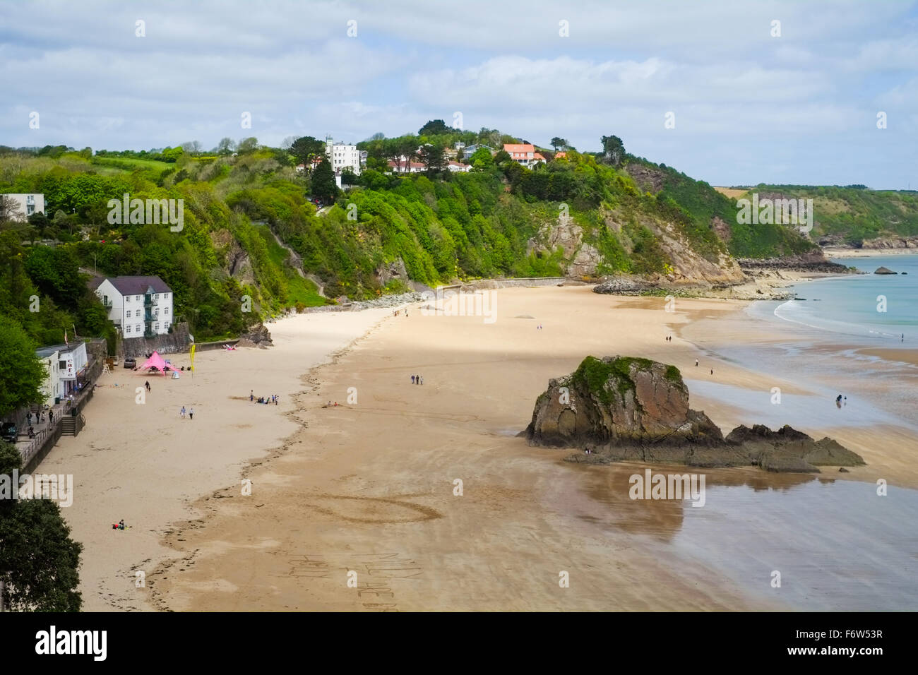 Tenby North Beach under an ebbing tide featuring the prominent Gosker ...