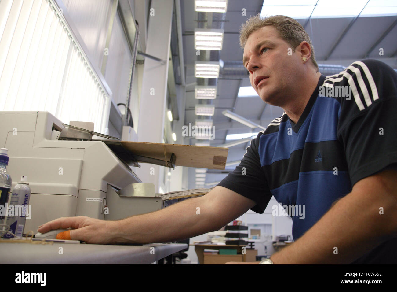 Man with epilepsy working as scanning operator in direct marketing ...