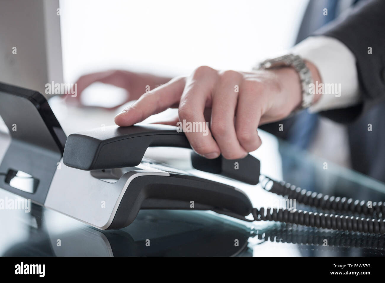 Hand picking up telephone receiver hi-res stock photography and images ...