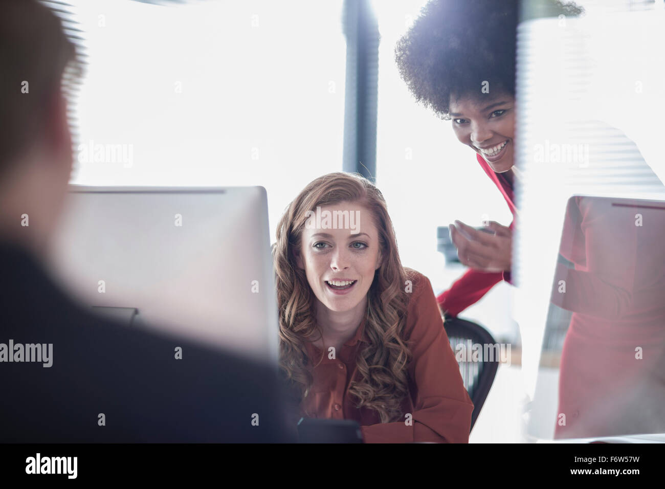 Three colleagues talking in office Stock Photo - Alamy
