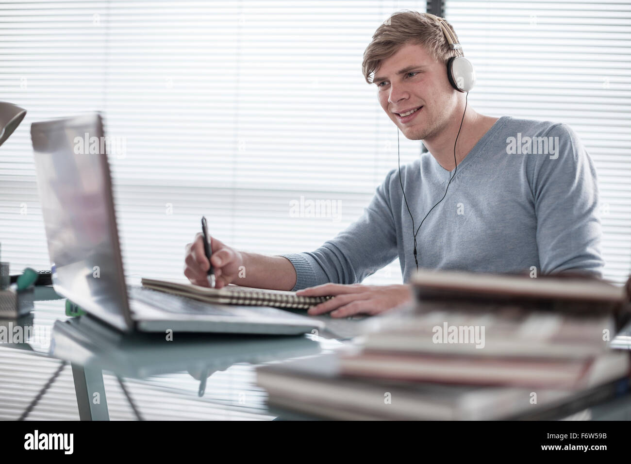 Man at office desk wearing headphones Stock Photo - Alamy