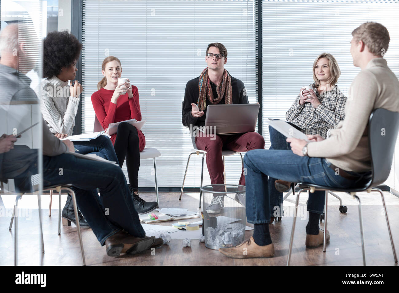 Colleagues in office having an informal meeting Stock Photo - Alamy