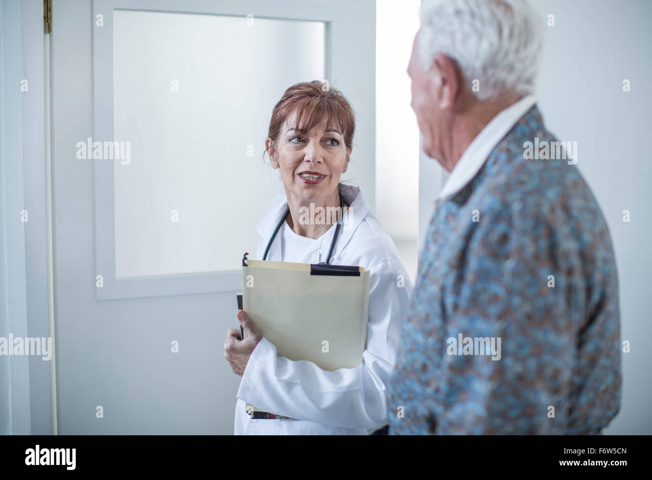Doctor with elderly patient in hospital Stock Photo - Alamy