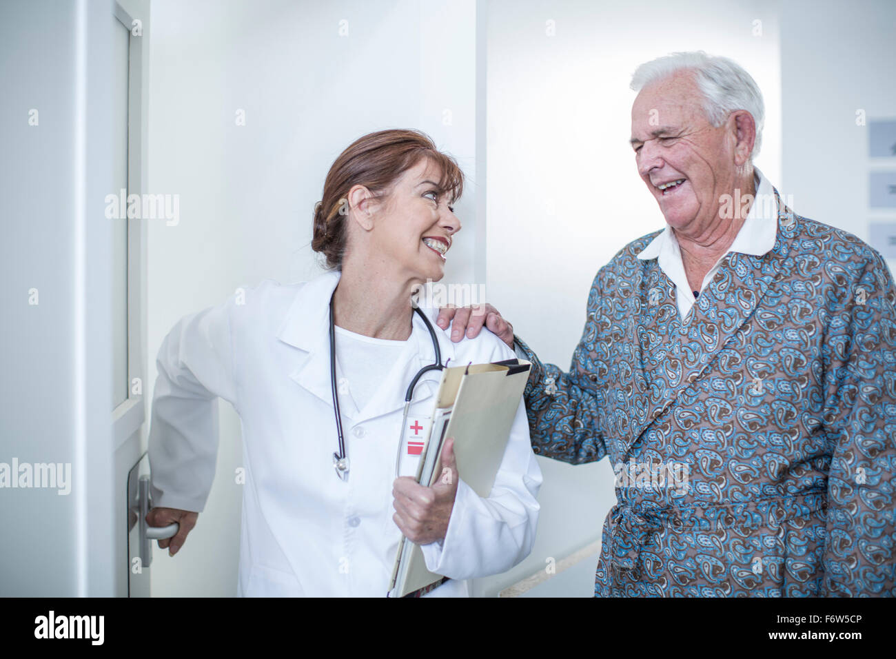 Doctor with elderly patient in hospital Stock Photo - Alamy