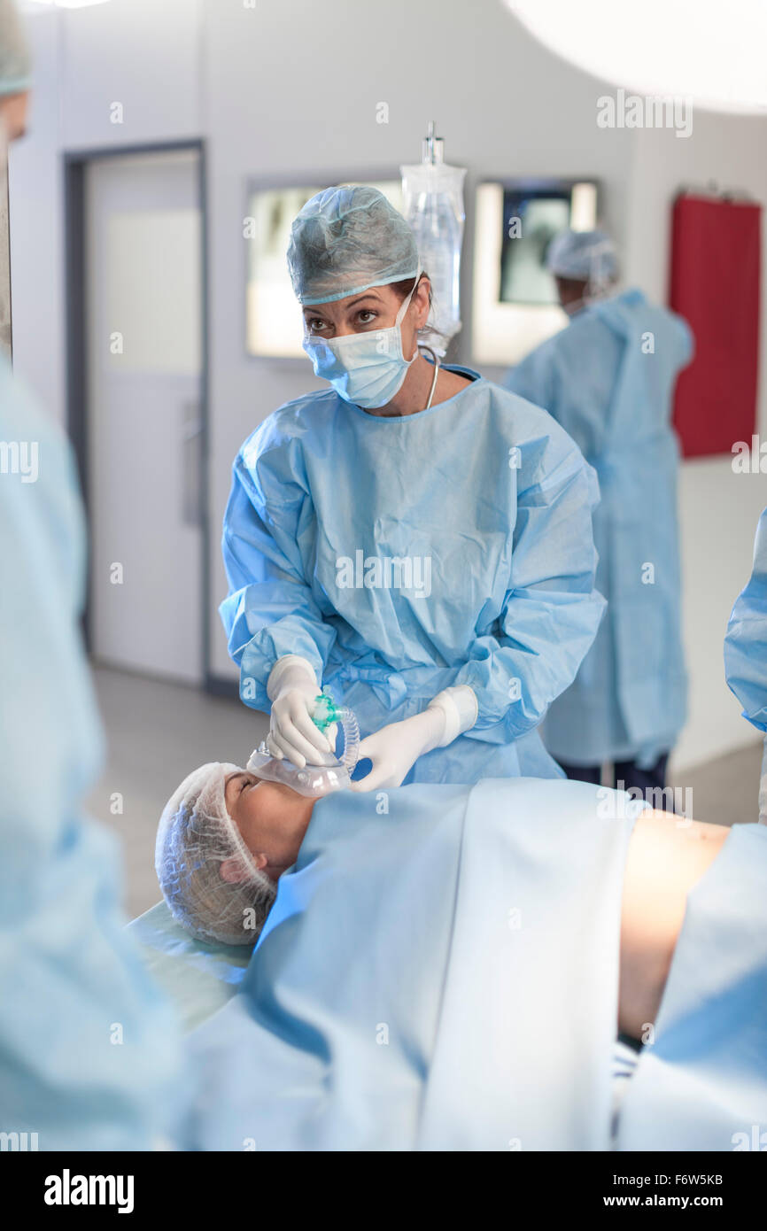 Surgical team anesthetizing patient Stock Photo - Alamy