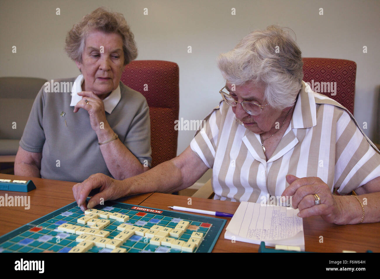 Two elderly women playing game of scrabble at day centre Stock Photo ...