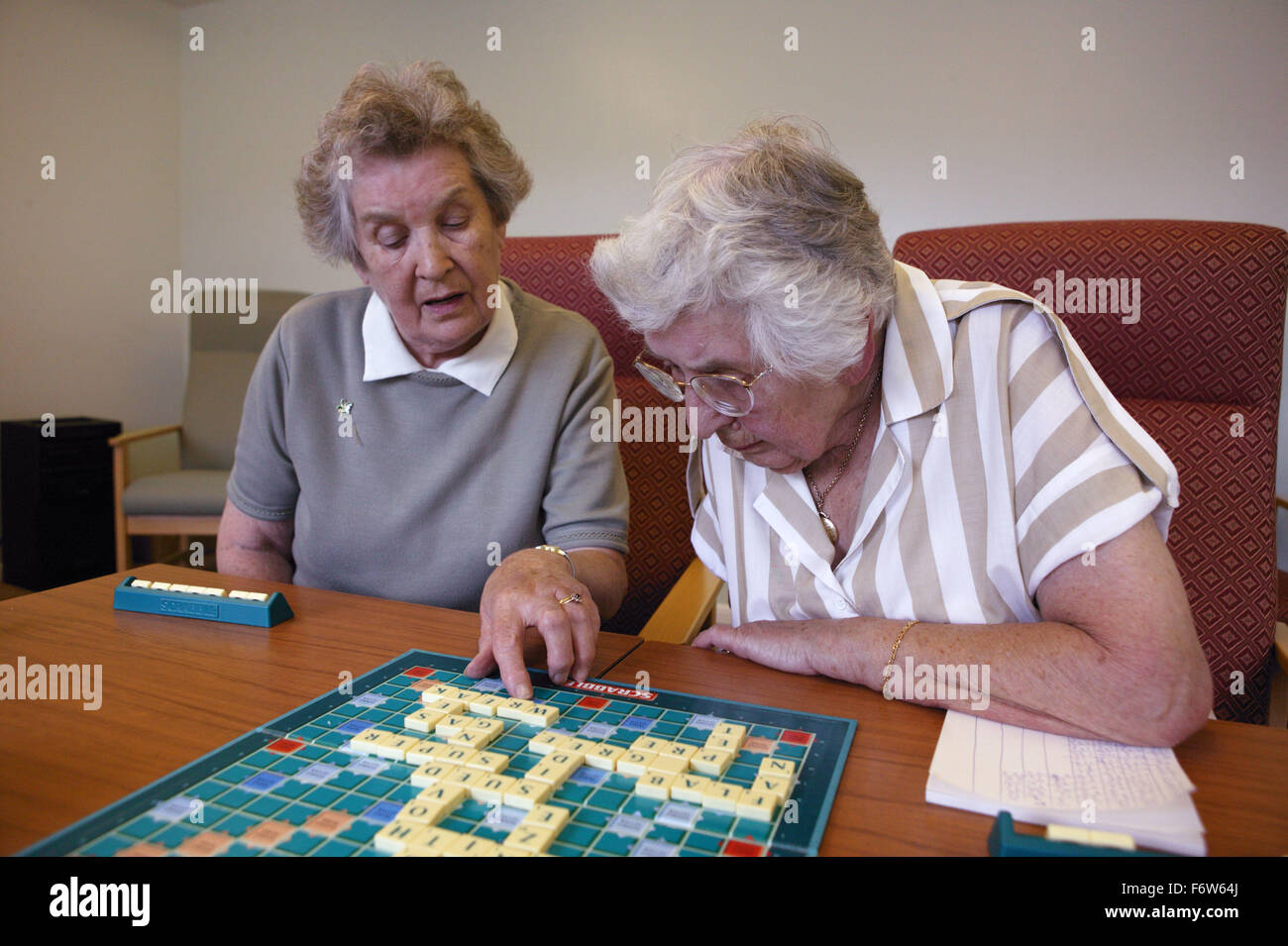 Two elderly women playing game of scrabble at day centre Stock Photo ...