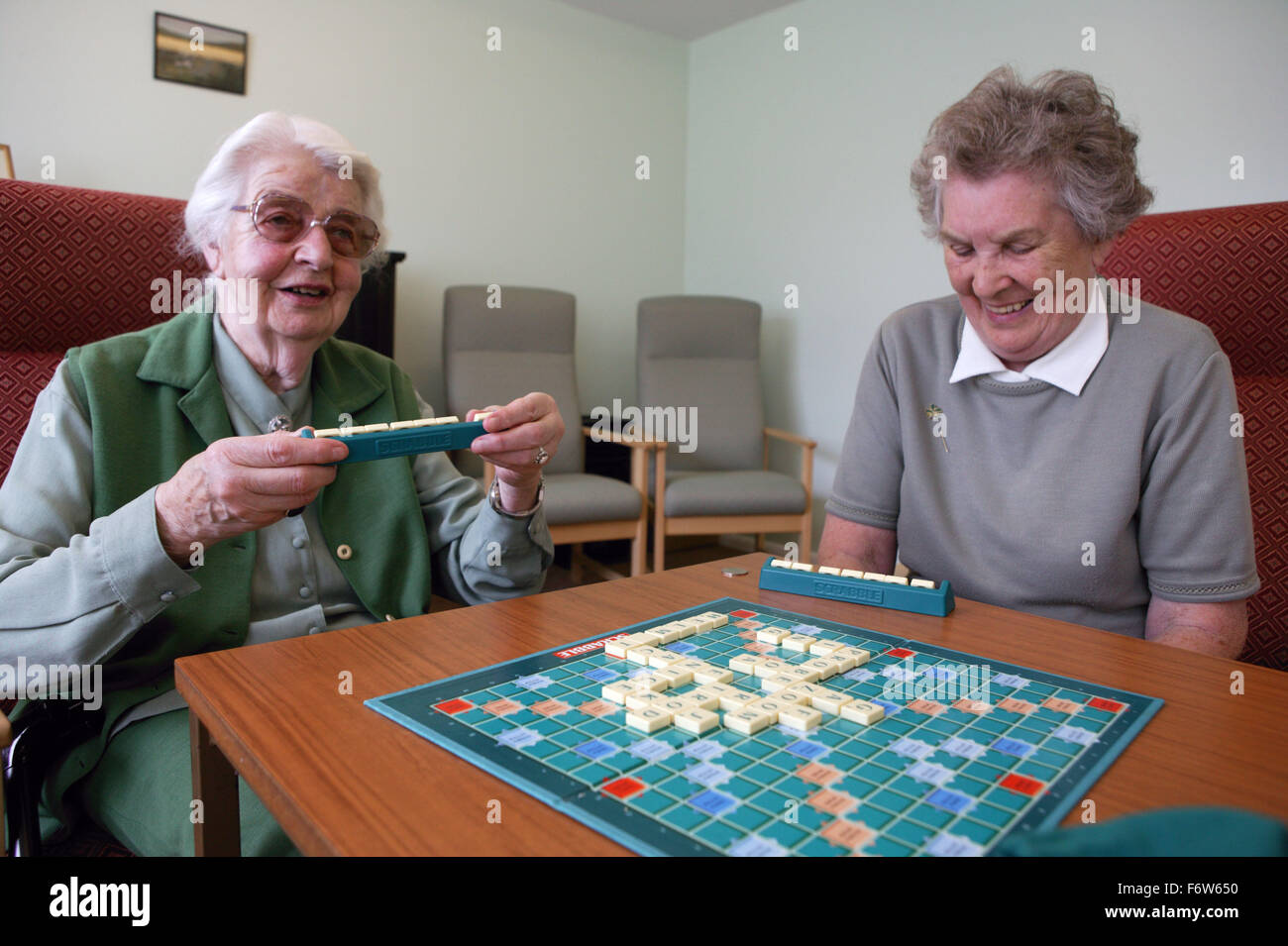 Two elderly women playing game of scrabble at day centre Stock Photo ...