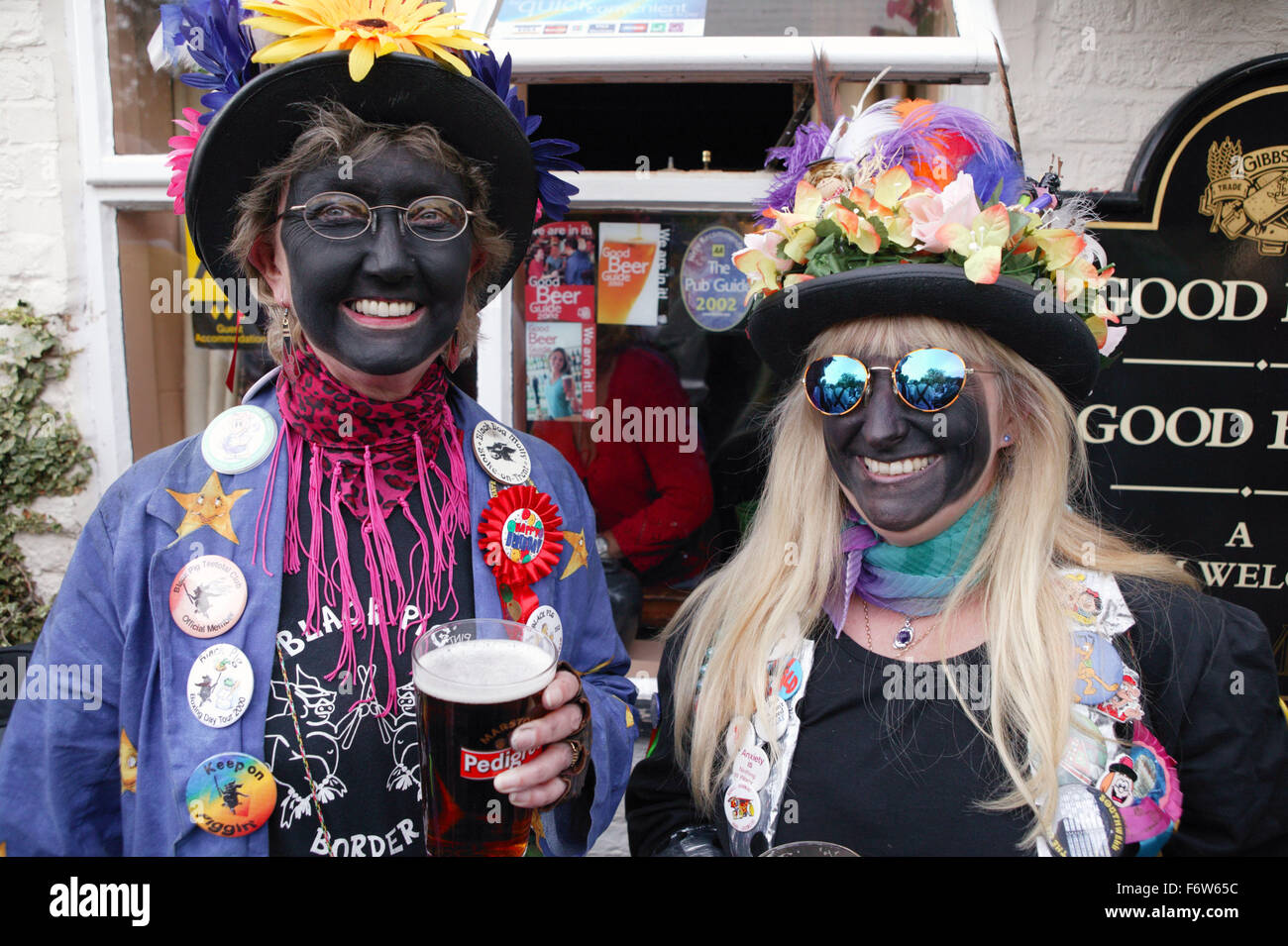 Portrait of two Morris dancers wearing costumes and makeup standing ...