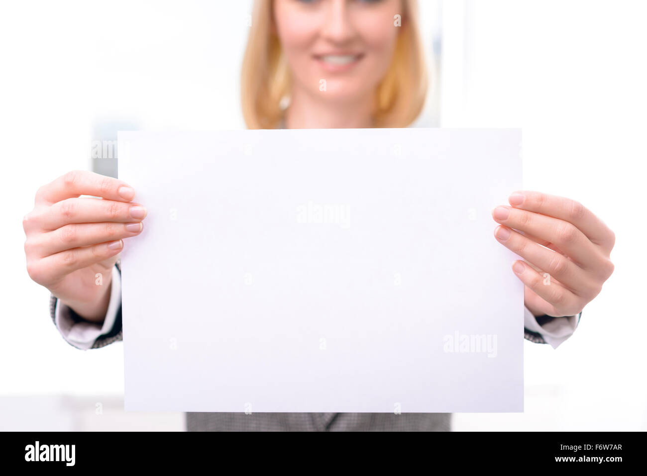Professional businesswoman holding sheet of paper Stock Photo - Alamy
