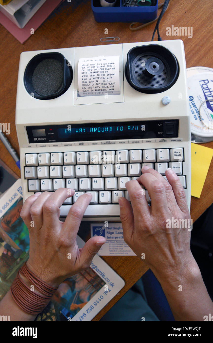 Woman using minicom with printer Stock Photo - Alamy