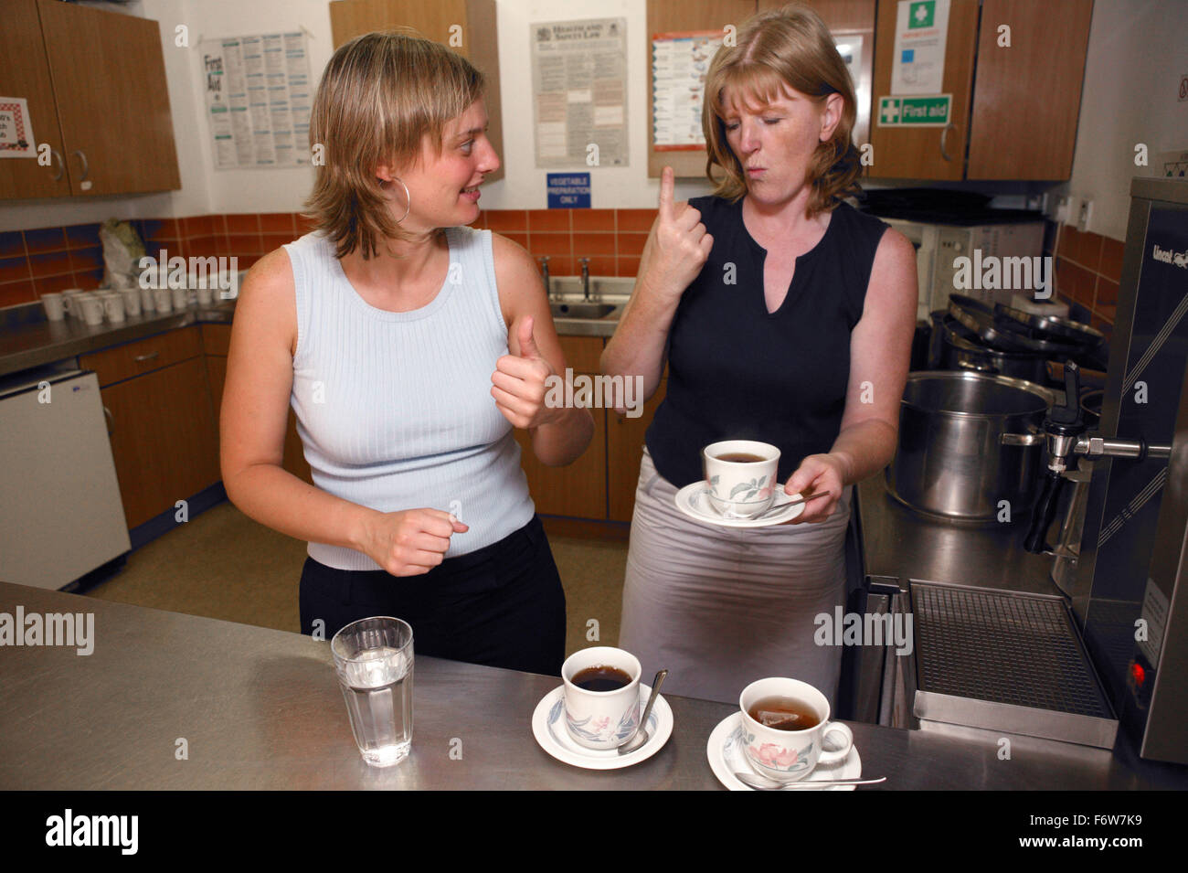 Woman in the kitchen using sign language Stock Photo - Alamy