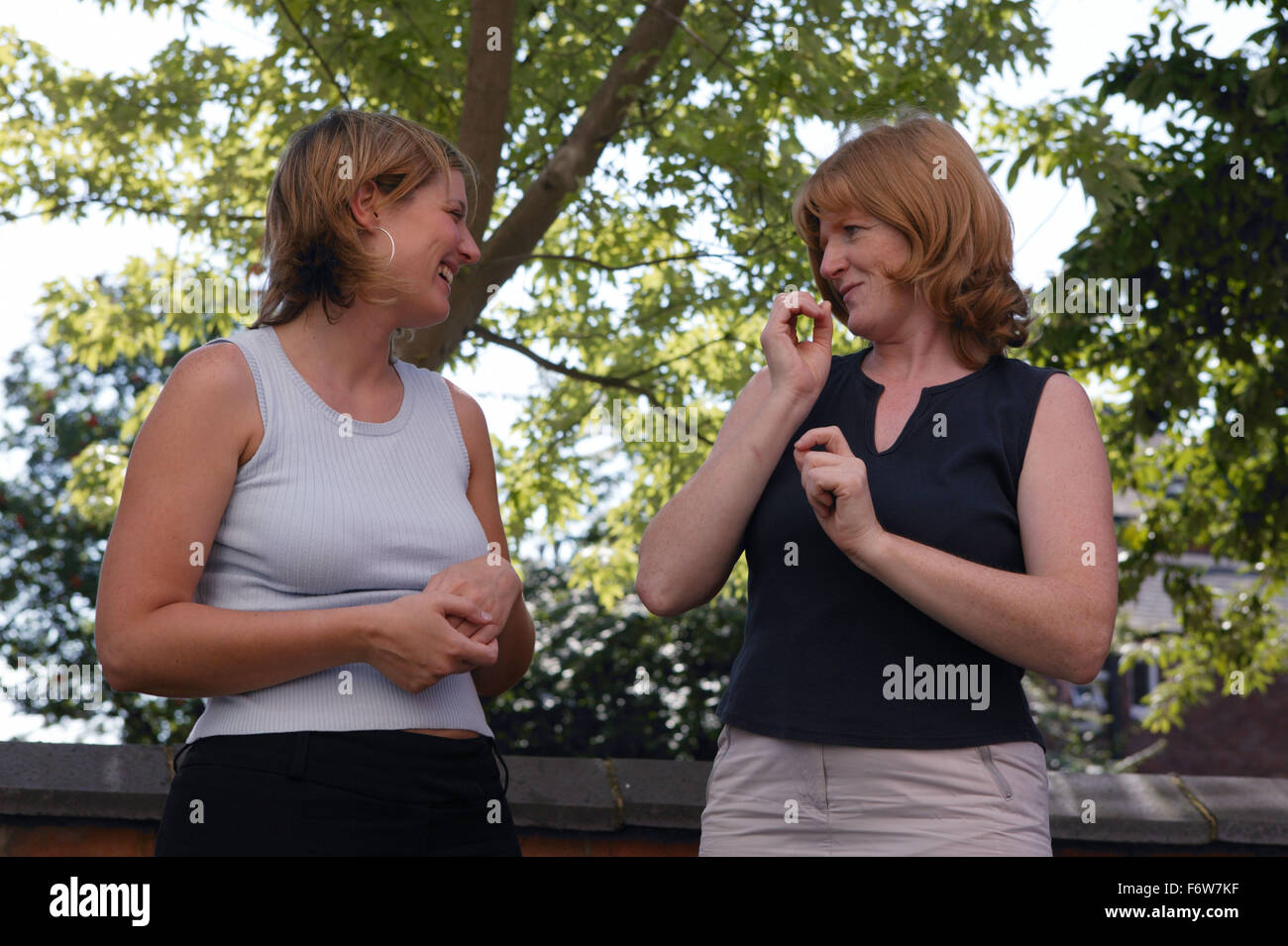 Women using sign language Stock Photo - Alamy
