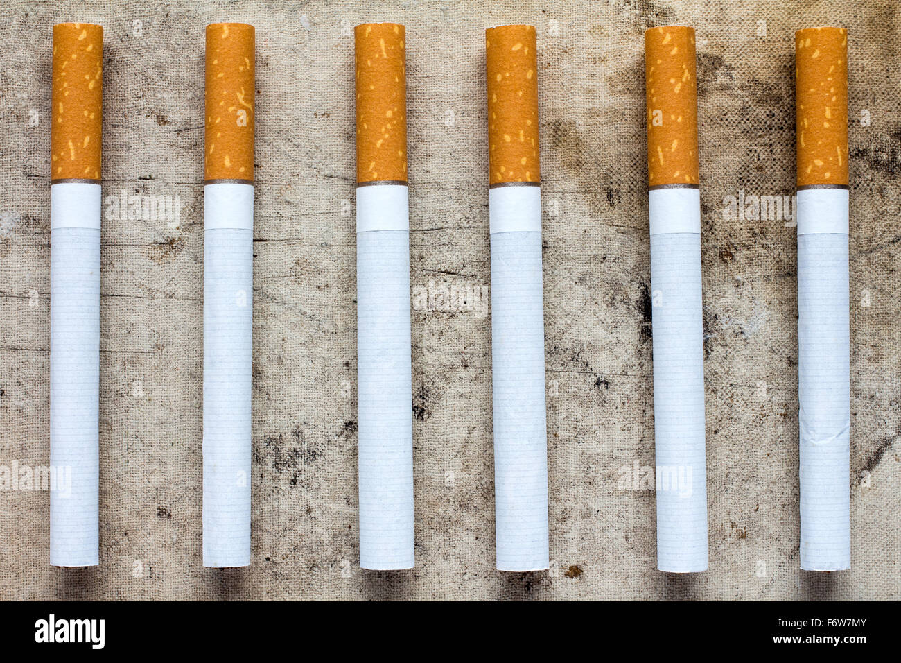 Six cigarettes with filters in a row on dirty background Stock Photo ...