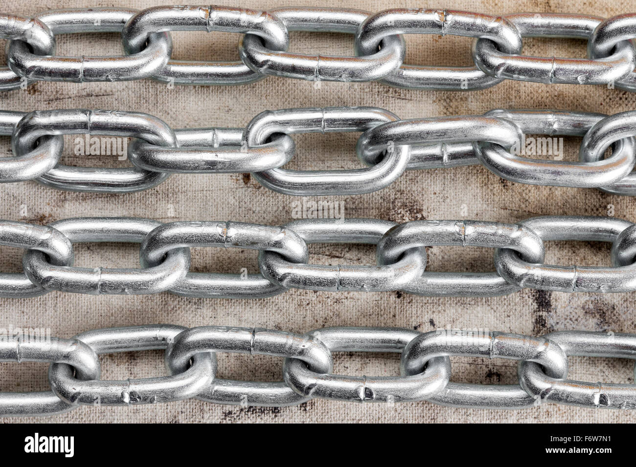 Four chains crossing old dirty canvas background Stock Photo - Alamy