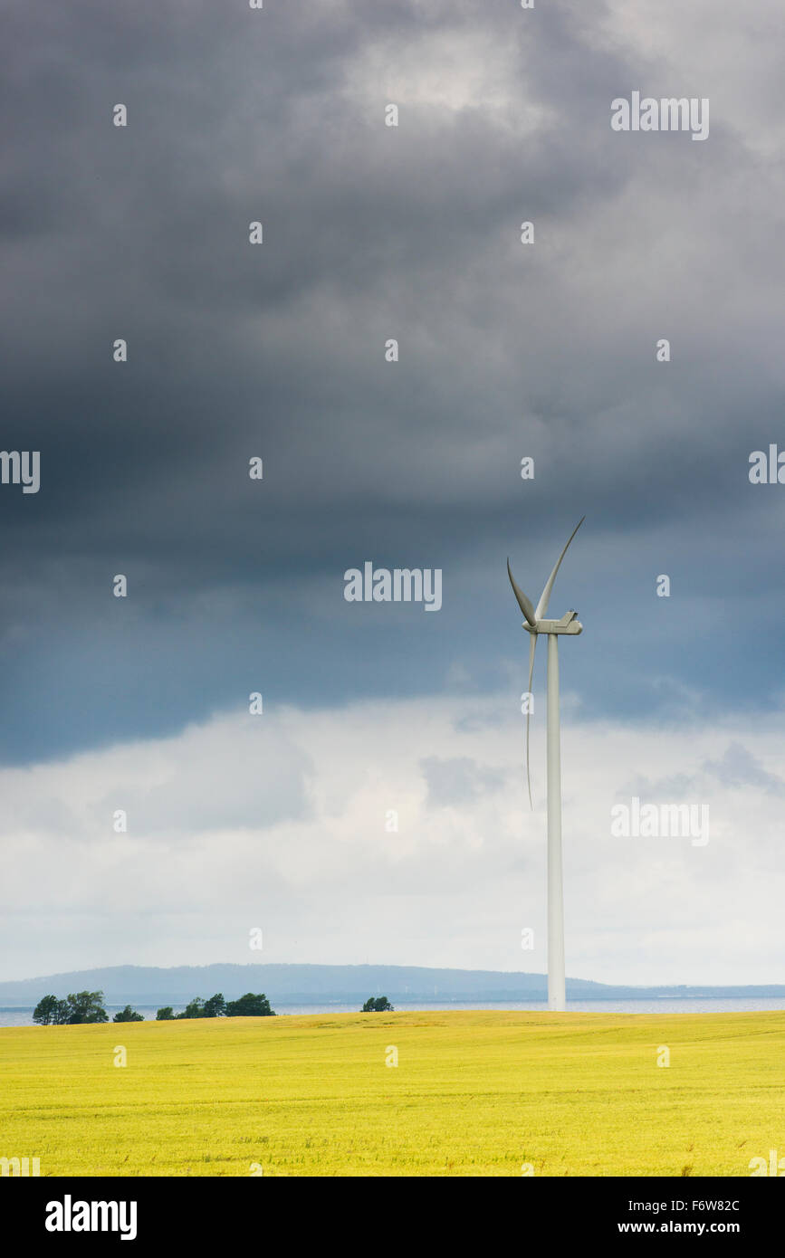 Natural landscape with modern windmills and sky with heavy rain clouds ...